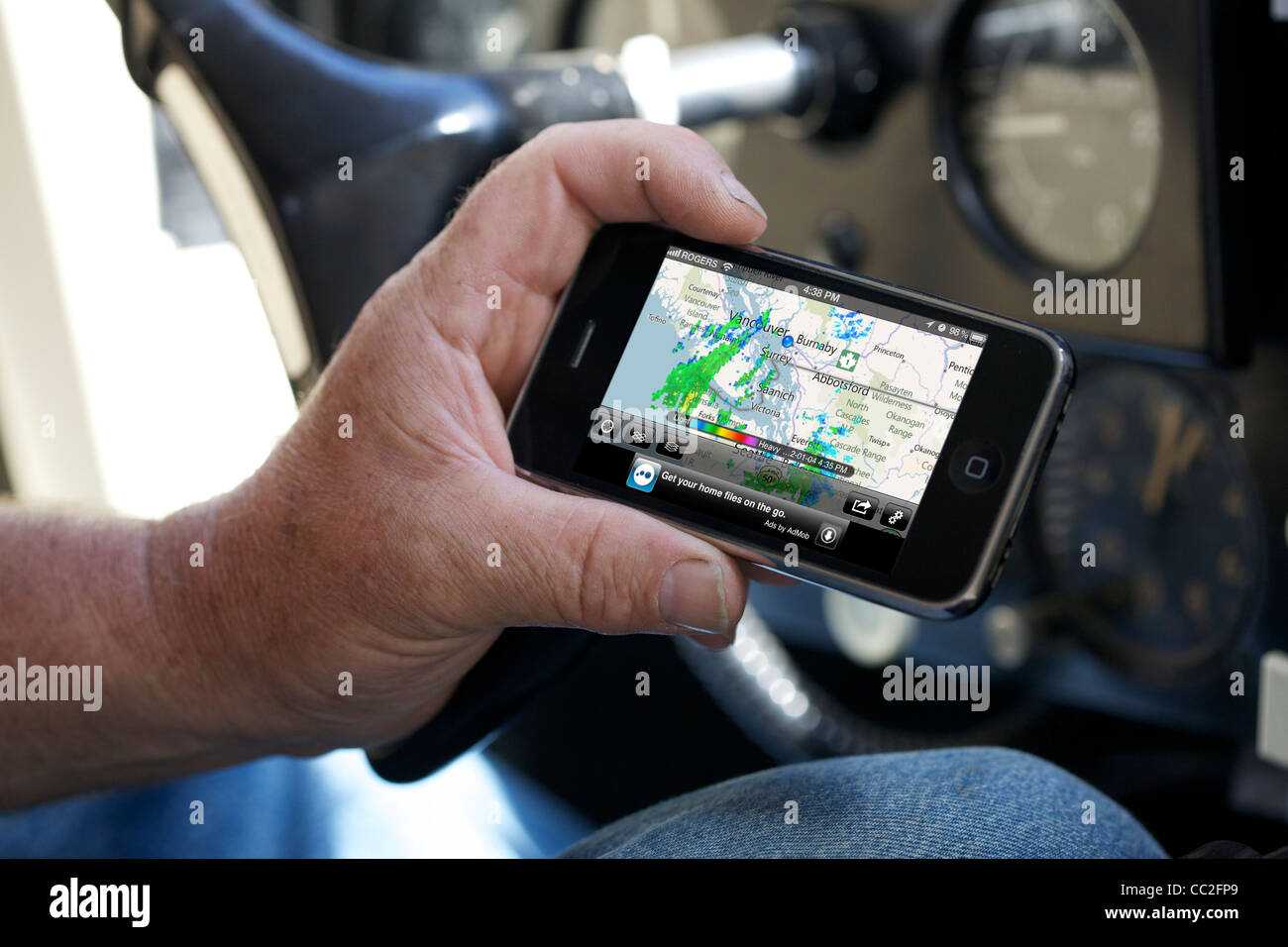 Private airplane pilot checking weather condition before flying with ...