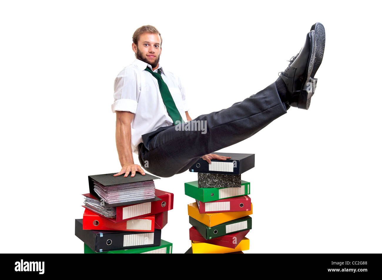 Businessman doing exercises over stack of files Stock Photo - Alamy