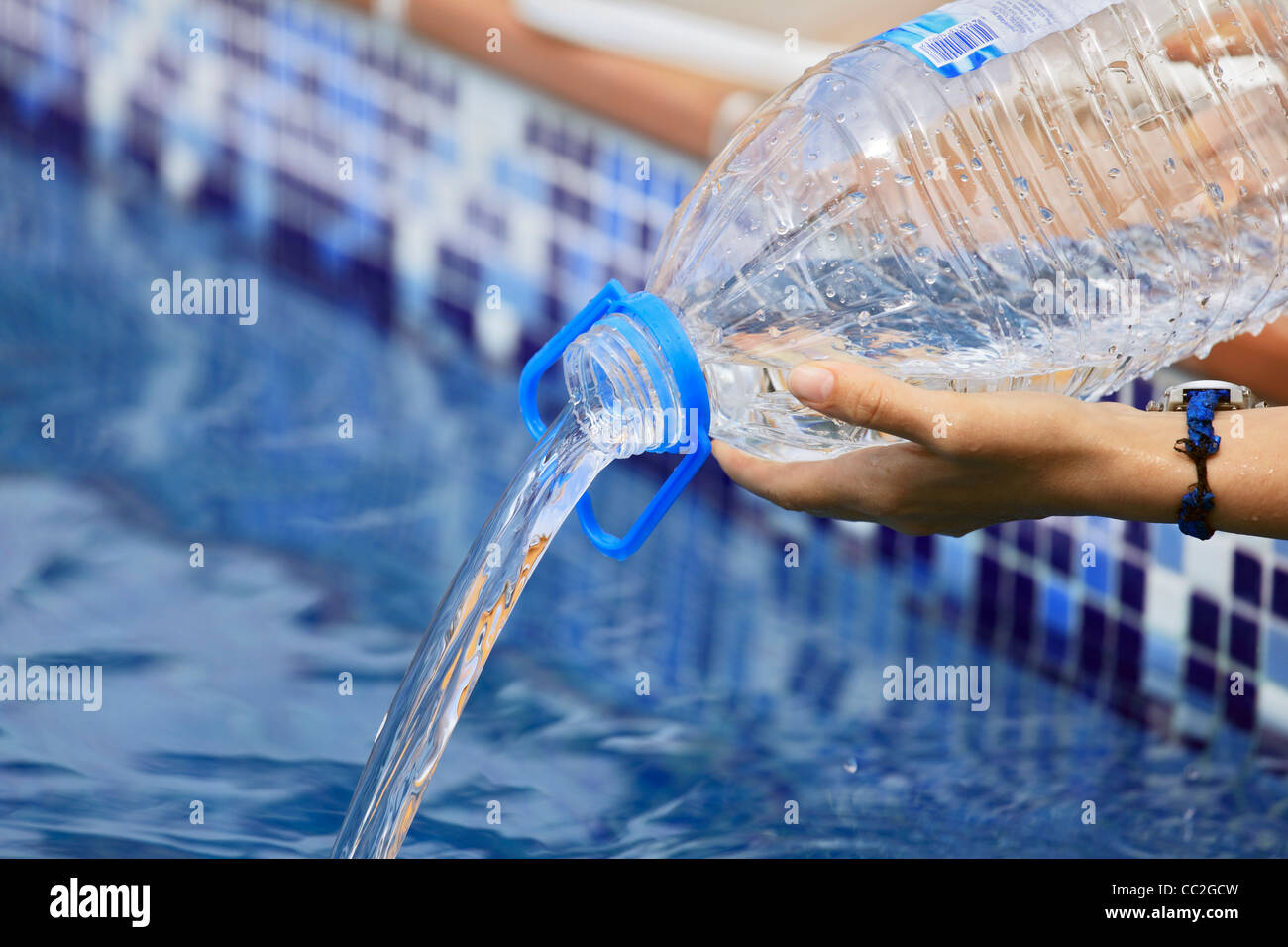 pouring bottled water out into a pool Stock Photo - Alamy