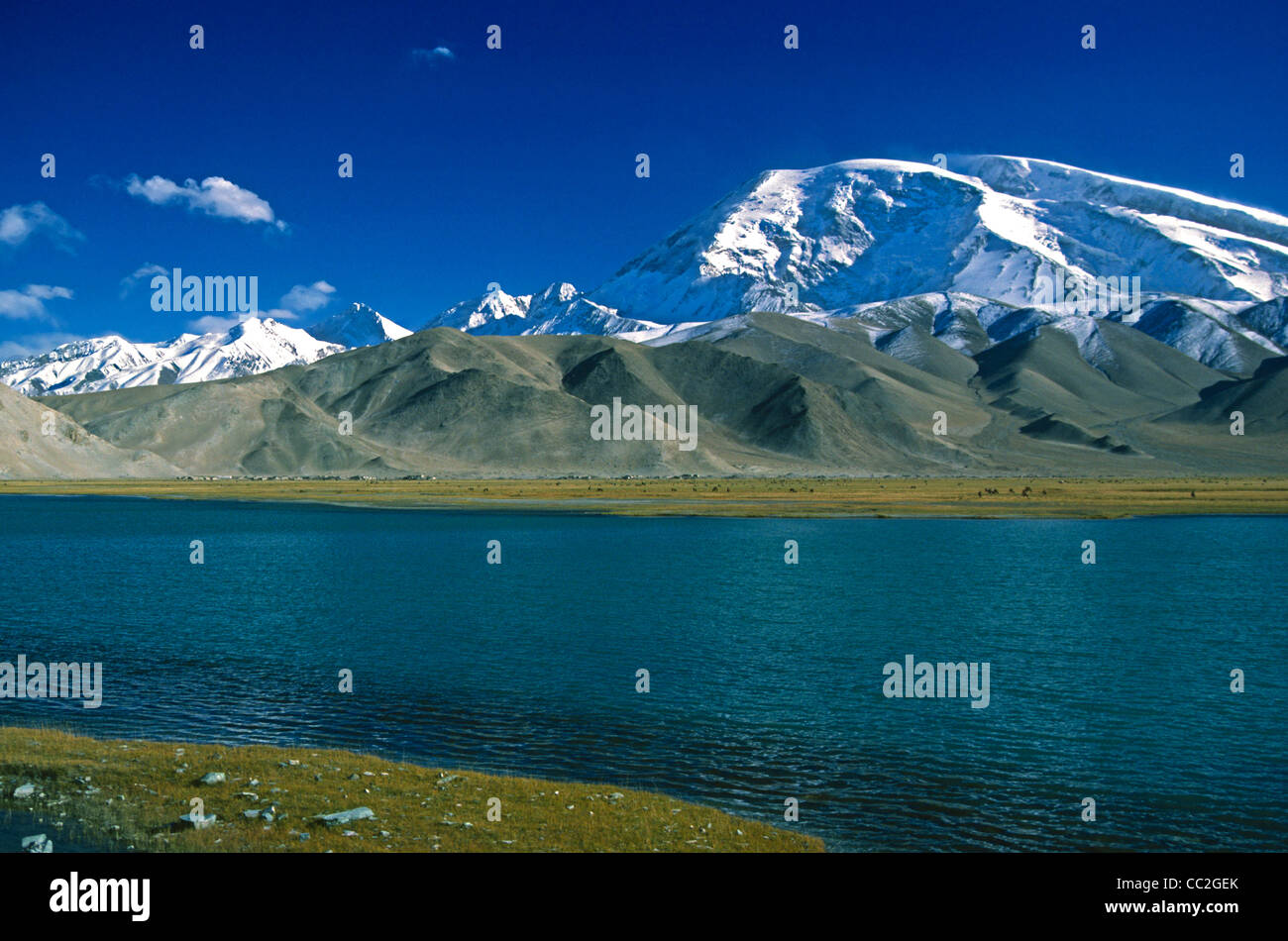 Snow capped mountains and lake Tian Shan Mountains Xinjiang China Stock ...