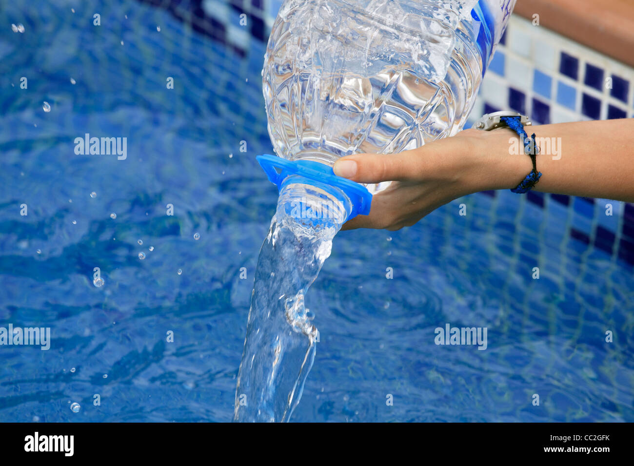 pouring bottled water out into a pool Stock Photo - Alamy