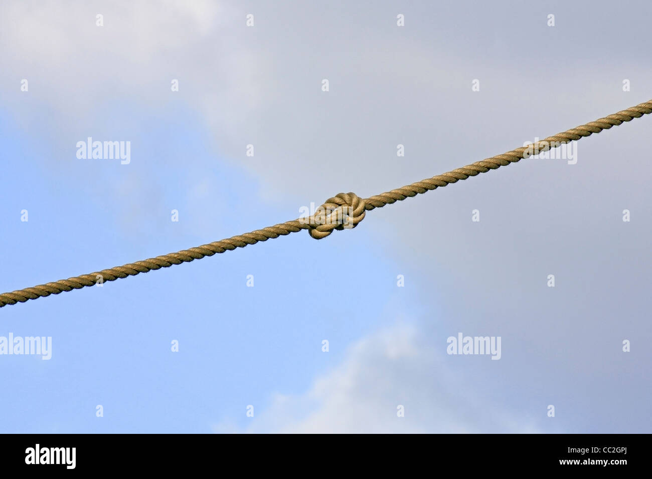 diagonal tensioned rope with knot against sky Stock Photo - Alamy