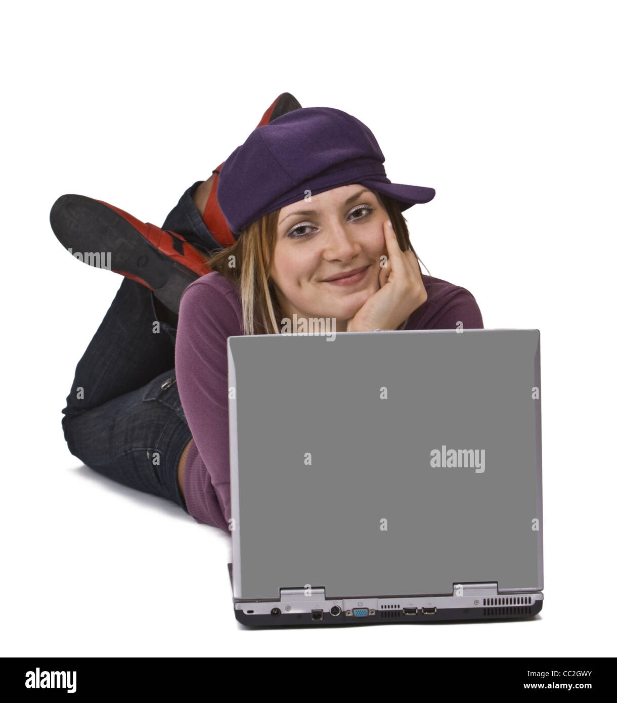 Young woman lying down and working on a laptop Stock Photo - Alamy