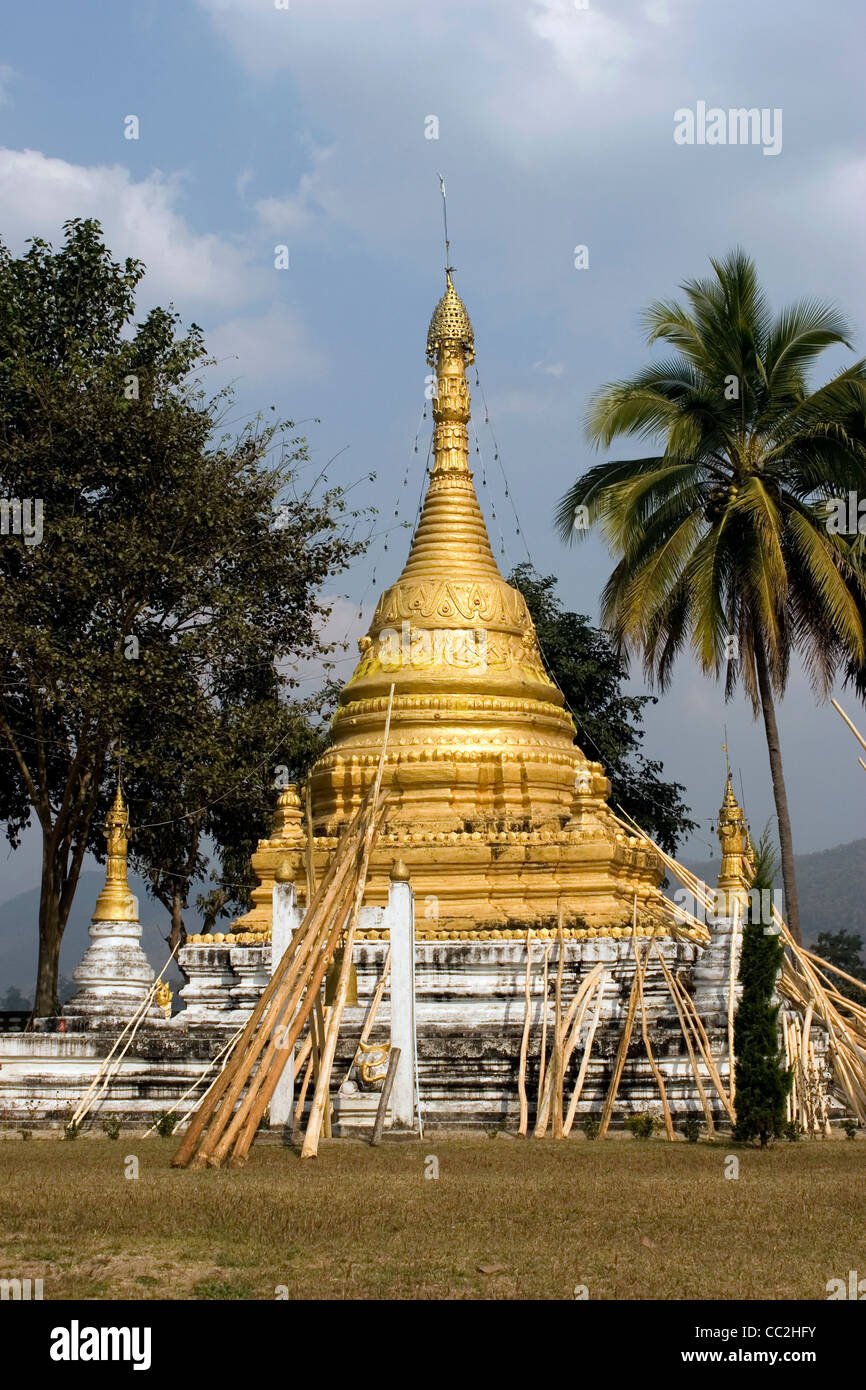 A gold stupa at a Buddhist temple is under repair at a wat near Pai ...