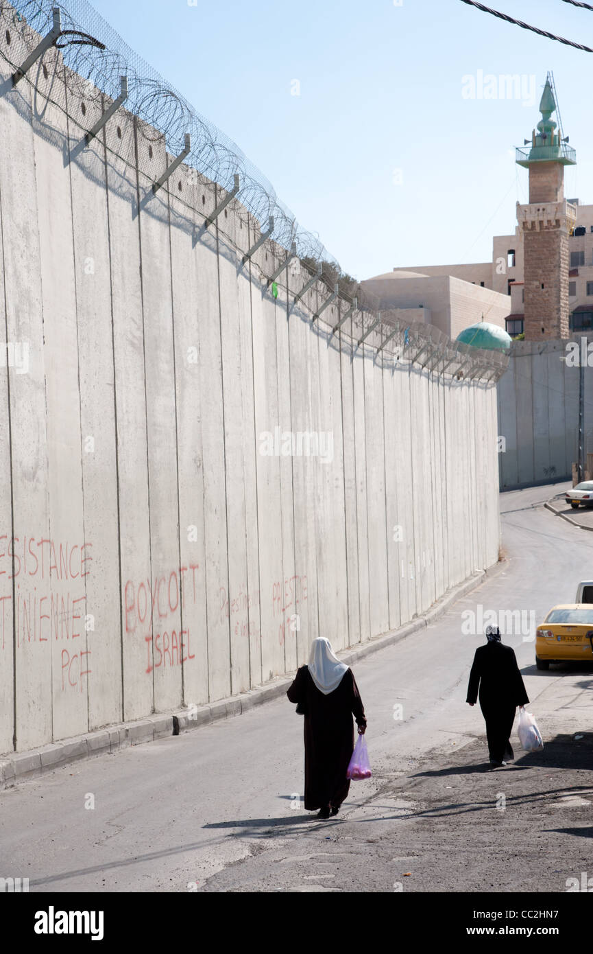 The Israeli separation wall divides the Palestinian neighborhood of Abu ...