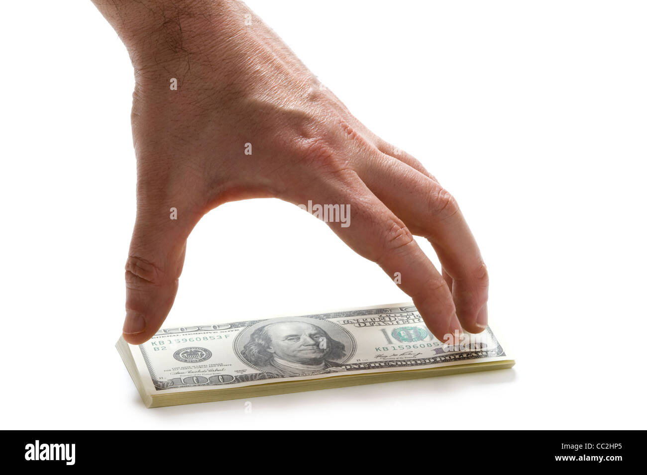 a male hand reaching for a wad of american 100 (hundred) dollar bills ...