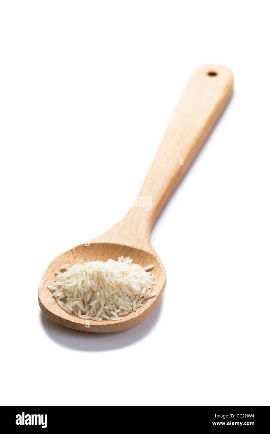 uncooked basmati rice on a wooden spoon Stock Photo - Alamy