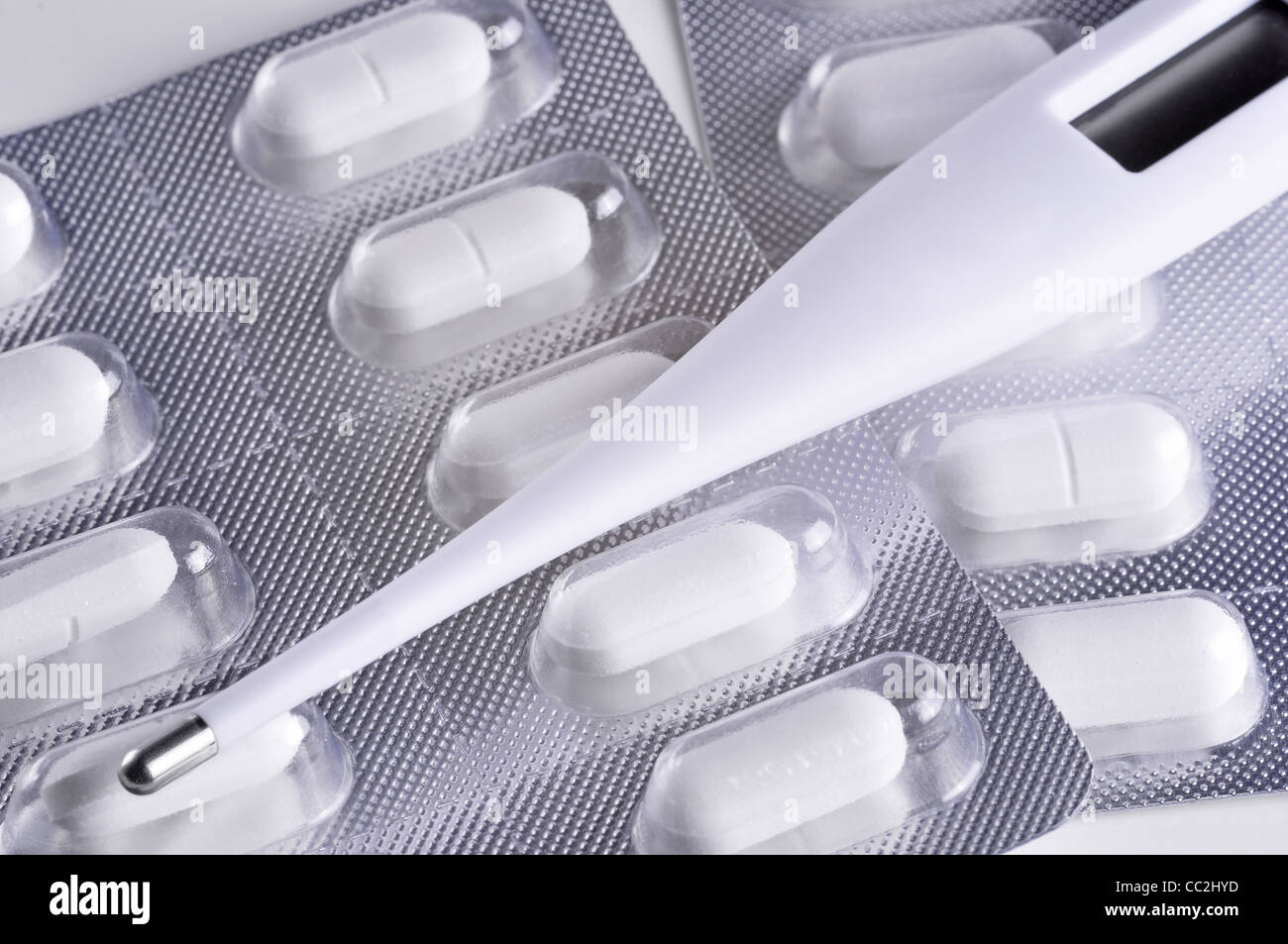 Thermometer on top of a tablet of pills Stock Photo - Alamy