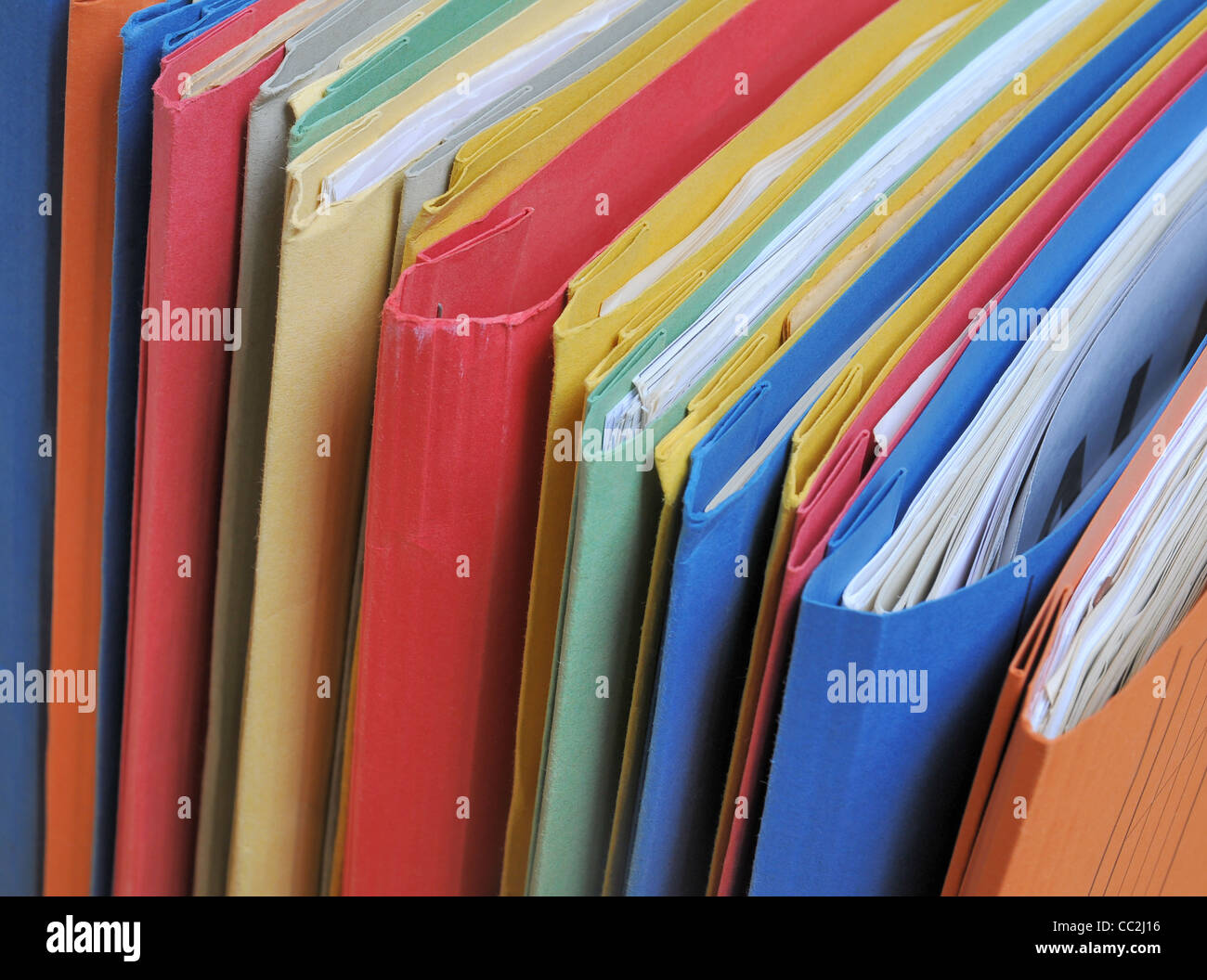 Row of colorful folders over white background Stock Photo - Alamy