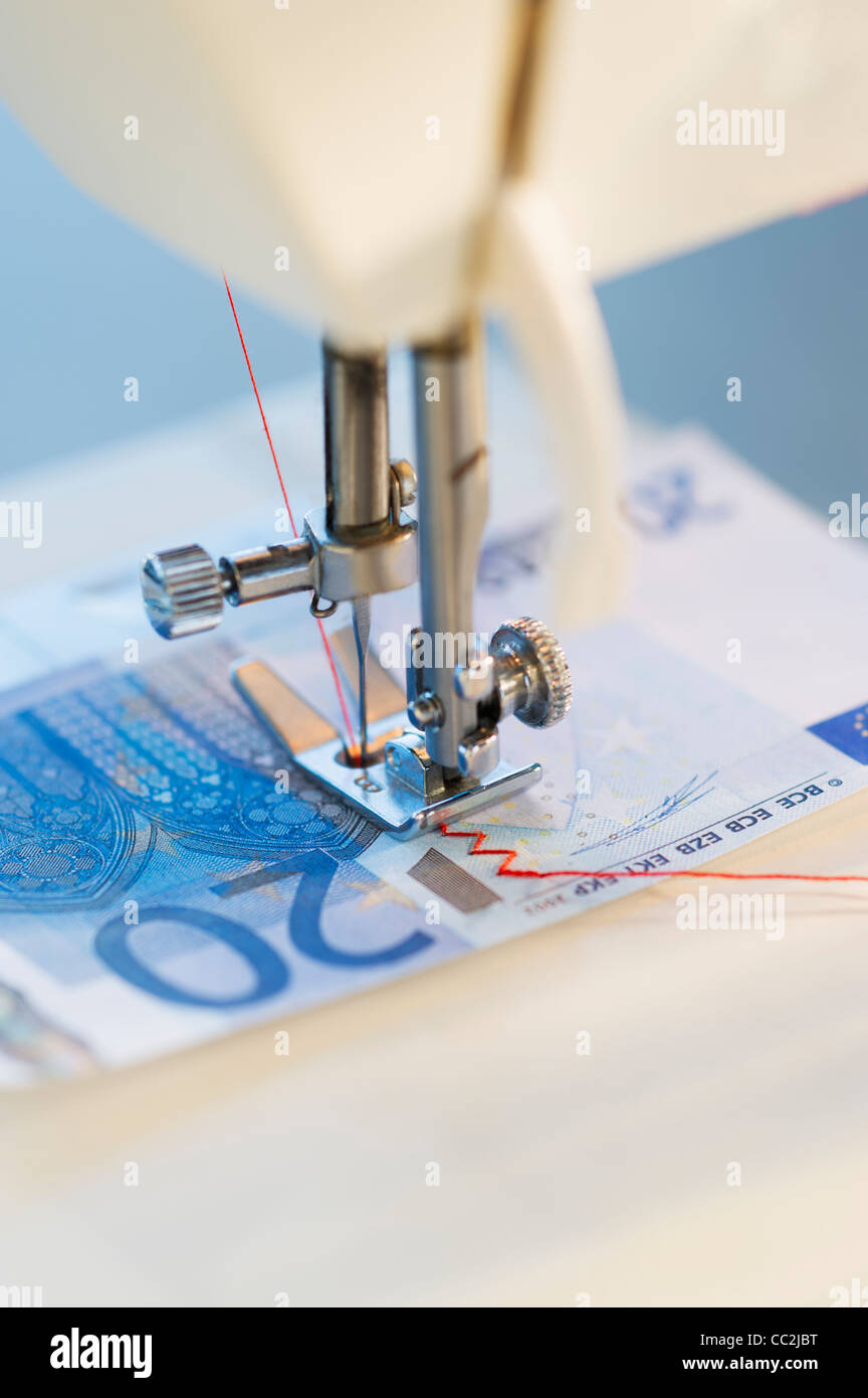 Sewing machine stitching 20 euro note, studio shot Stock Photo - Alamy