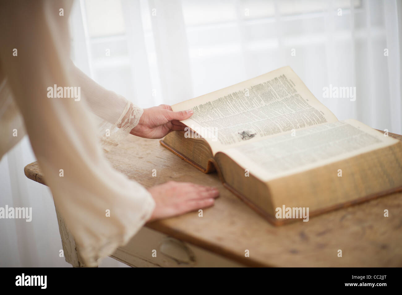 USA, New Jersey, Jersey City, Woman reading antique book Stock Photo ...