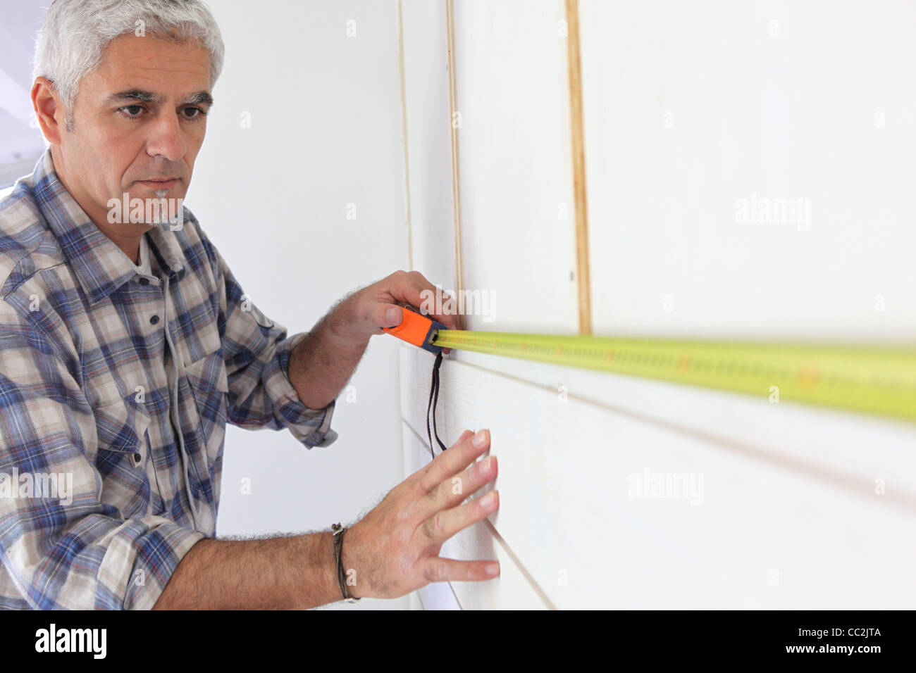 Builder measuring height tape measure hi-res stock photography and ...