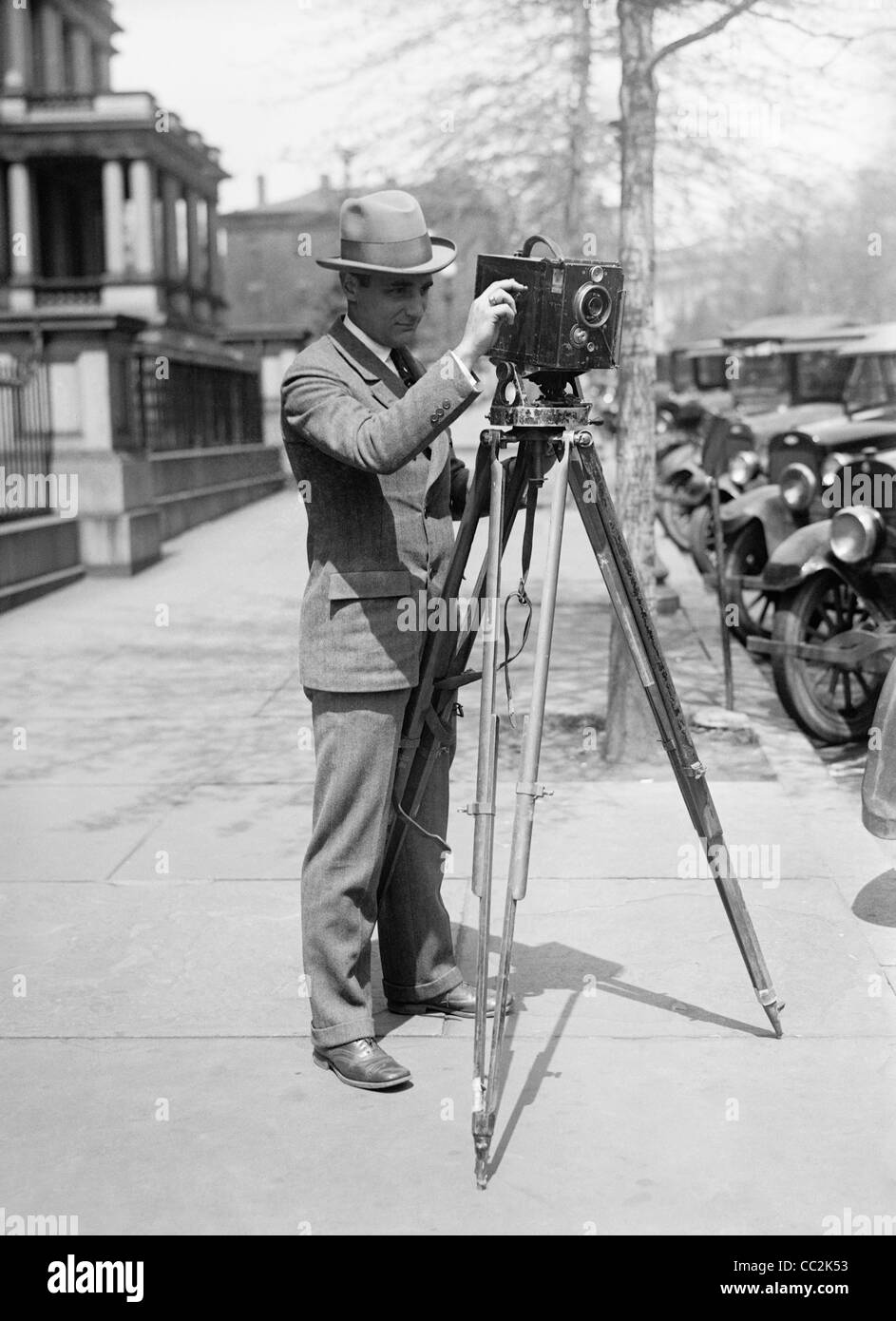 Photo circa 1910s of a photographer preparing to use a large old style ...