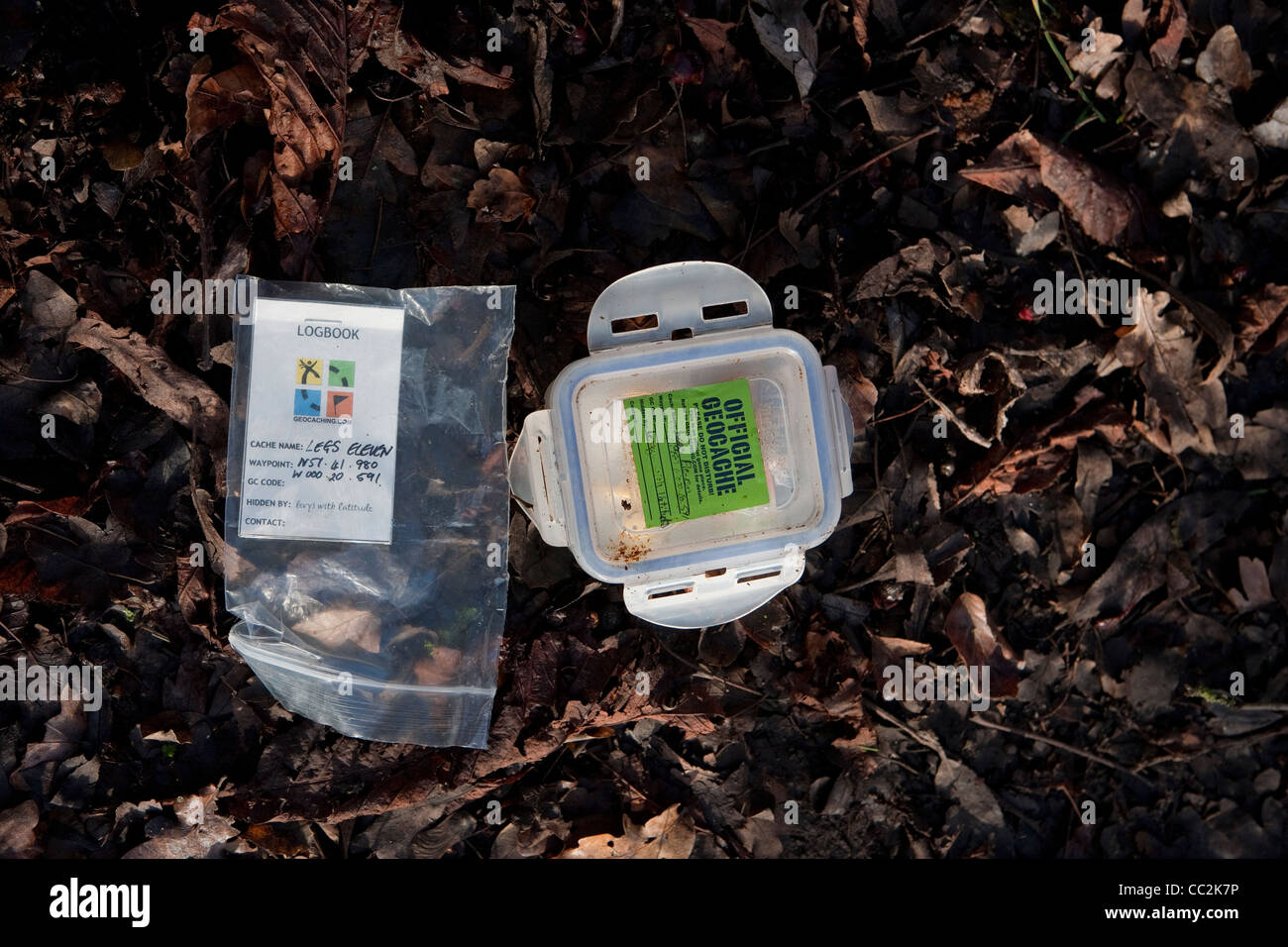 Geocache lid and log-book in a woodland area Stock Photo - Alamy