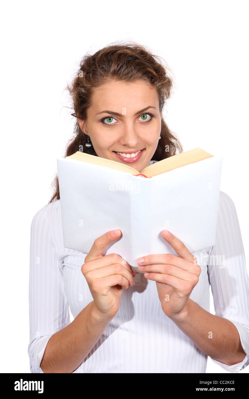 Beautiful green-eyed girl with a book looks into the camera on a white ...