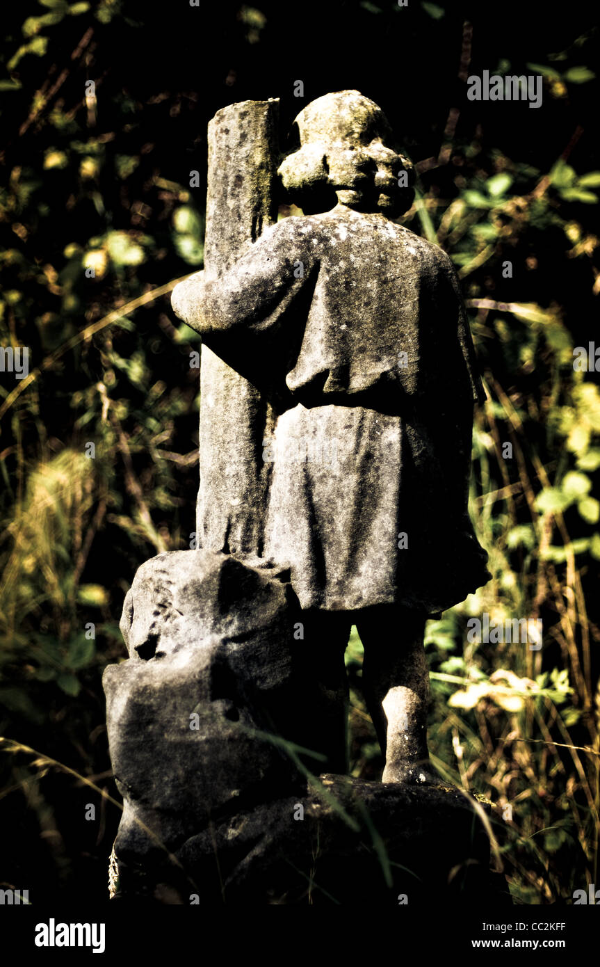 Statue of a young boy in cemetery Stock Photo - Alamy