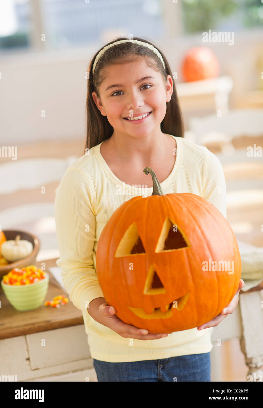 USA, New Jersey, Jersey City, Portrait of girl (10-11) holding Jack o ...