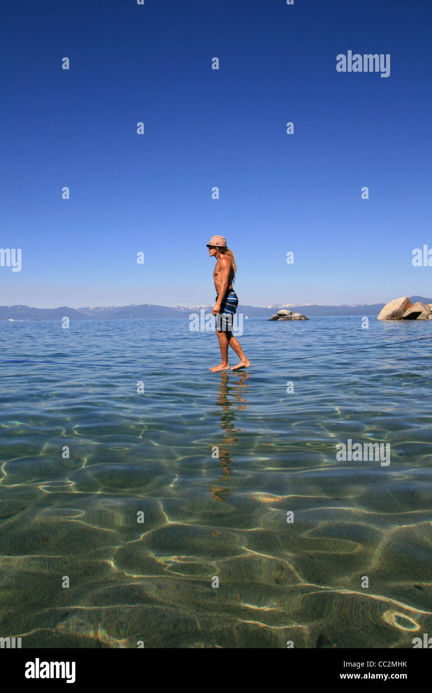 man slacklining above Lake Tahoe appears to walk on water Stock Photo ...