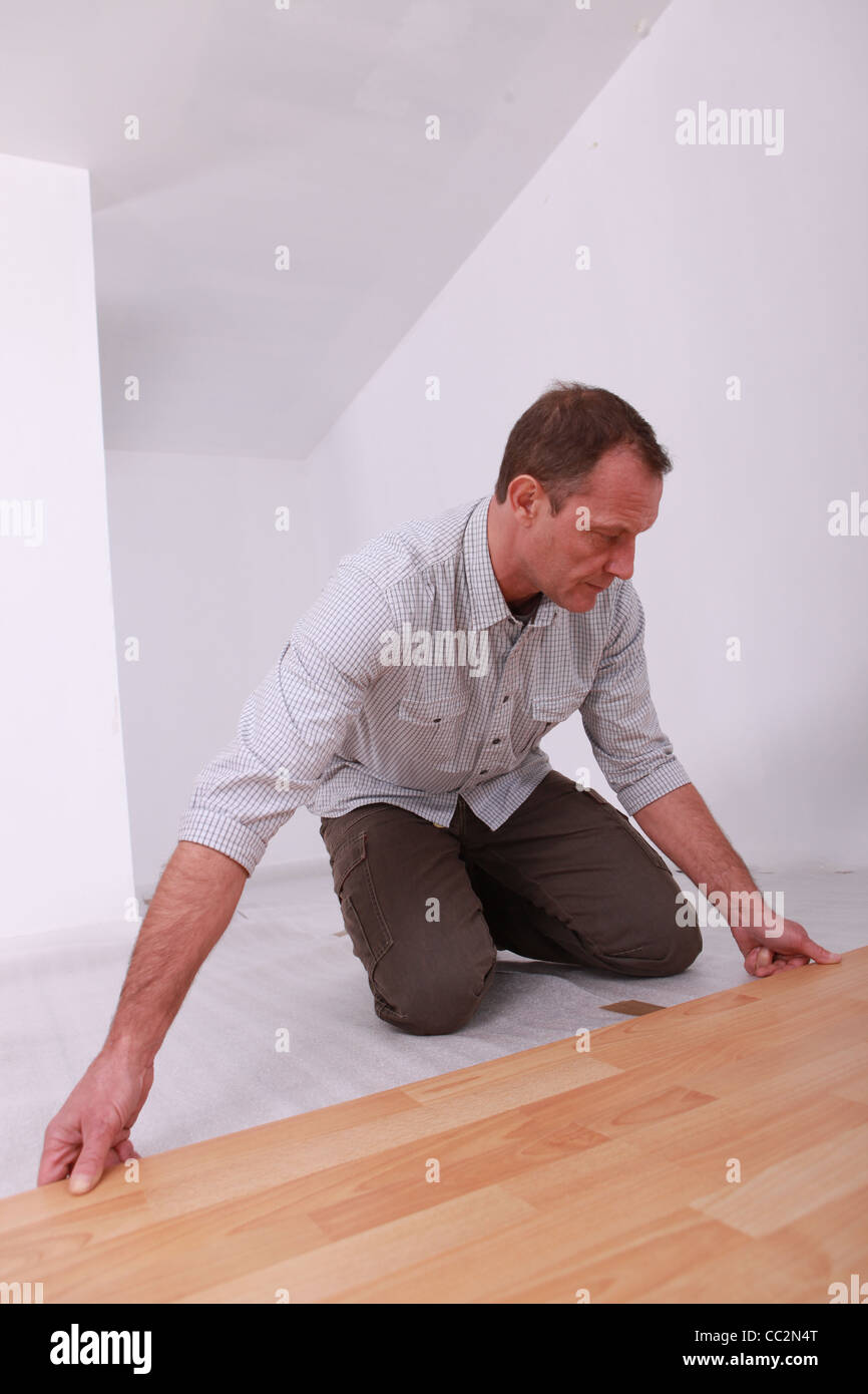 Man installing wooden flooring Stock Photo - Alamy
