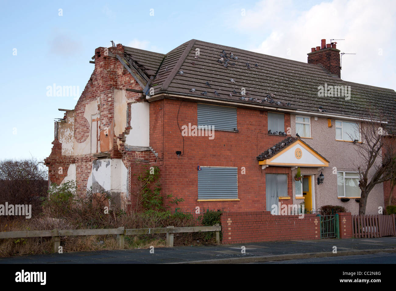 House in New Brighton with pigeons on the roof of the unoccupied ...