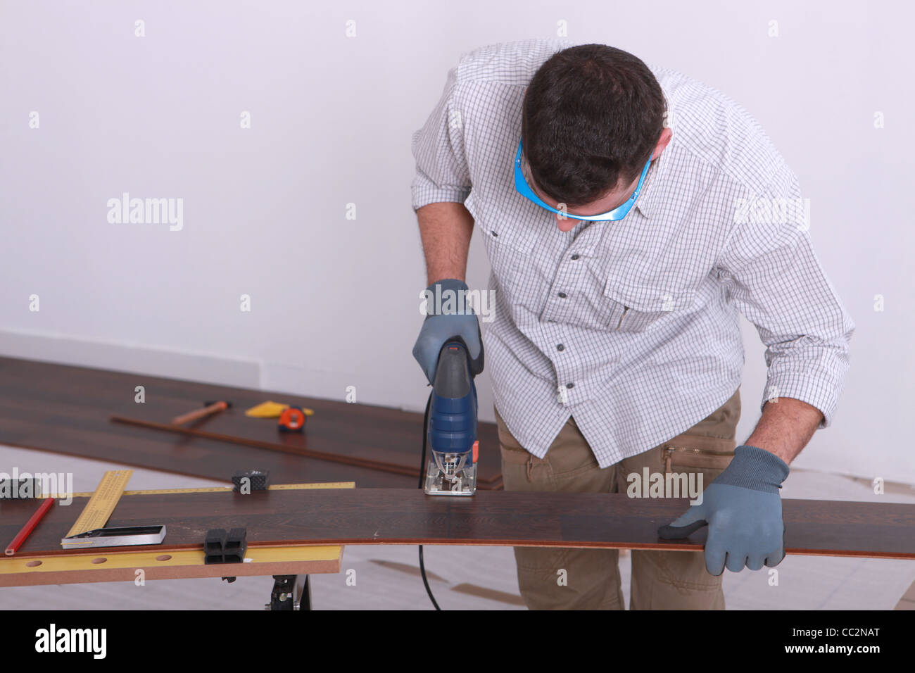 Man operating a jigsaw Stock Photo - Alamy