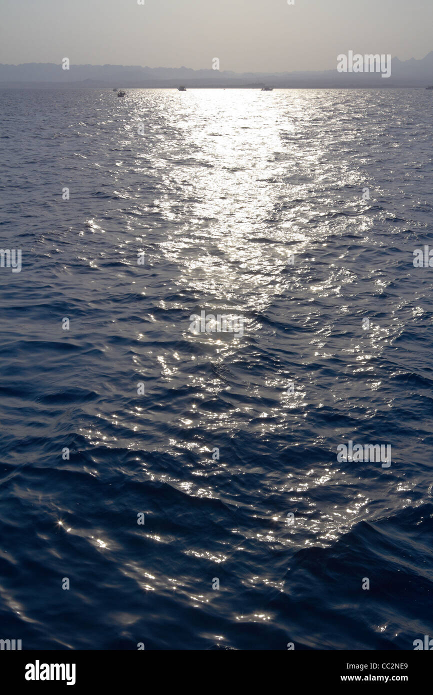 Sea water ripples with horizon in back lighting as background Stock ...