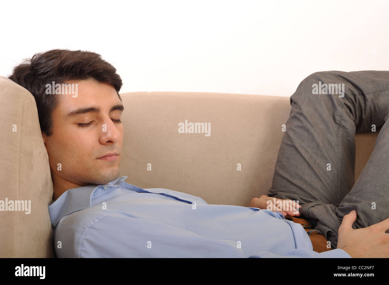 Man sleeping on the couch Stock Photo - Alamy