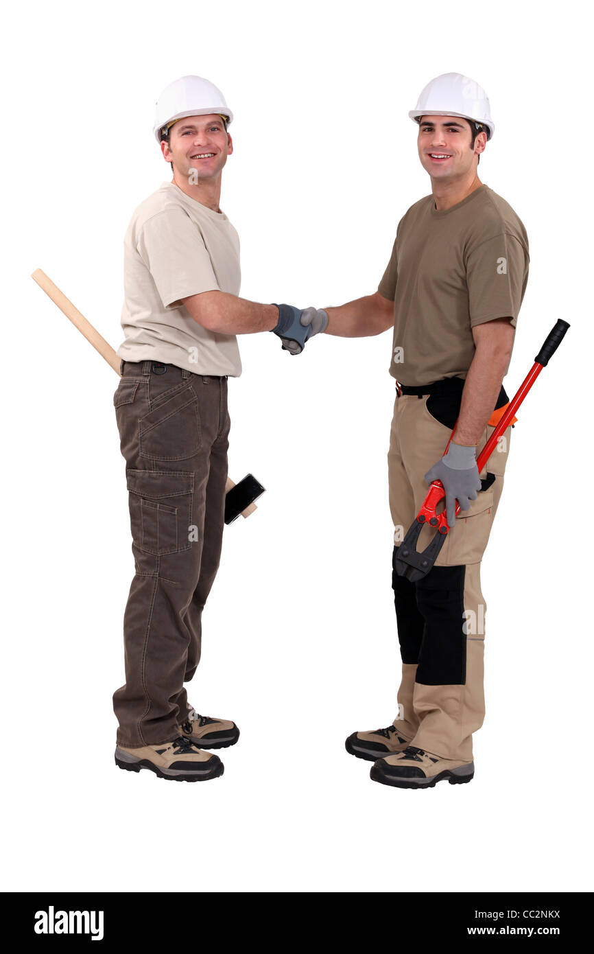 Tradesmen shaking hands Stock Photo - Alamy