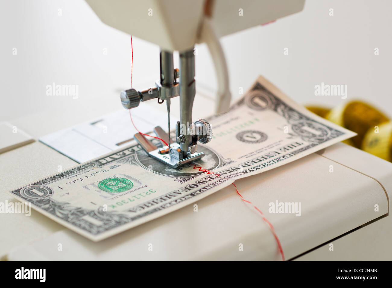 Halves of dollar bill being sewed with sewing machine Stock Photo - Alamy