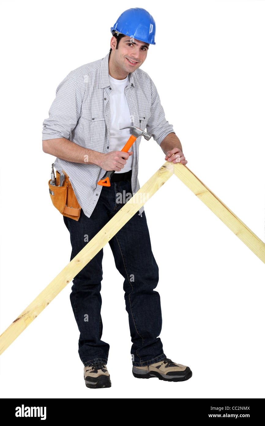 Carpenter nailing a frame Stock Photo - Alamy