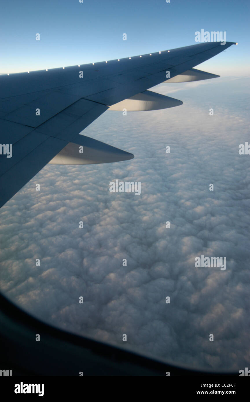 Jet liner flying above clouds at sunrise Stock Photo - Alamy