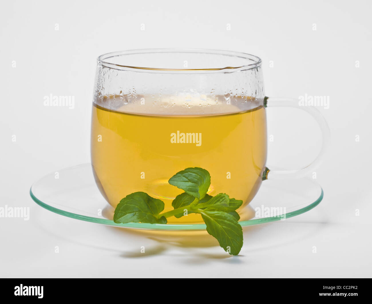 a cup with peppermint tea, beside are Peppermint leaves Stock Photo - Alamy
