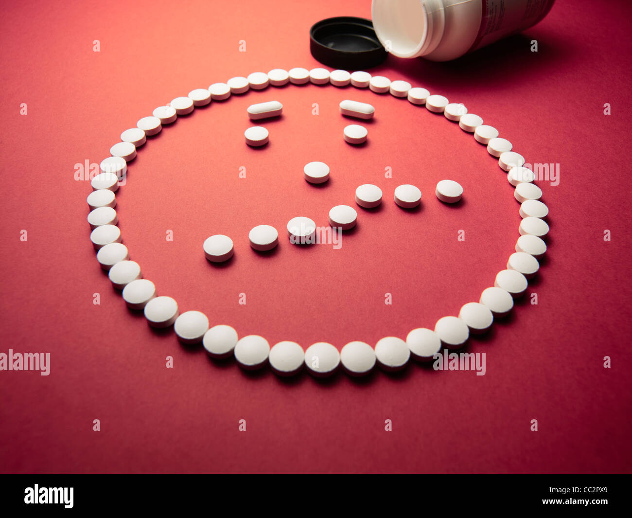 angry face made out of pills and drugs coming out of a bottle Stock ...