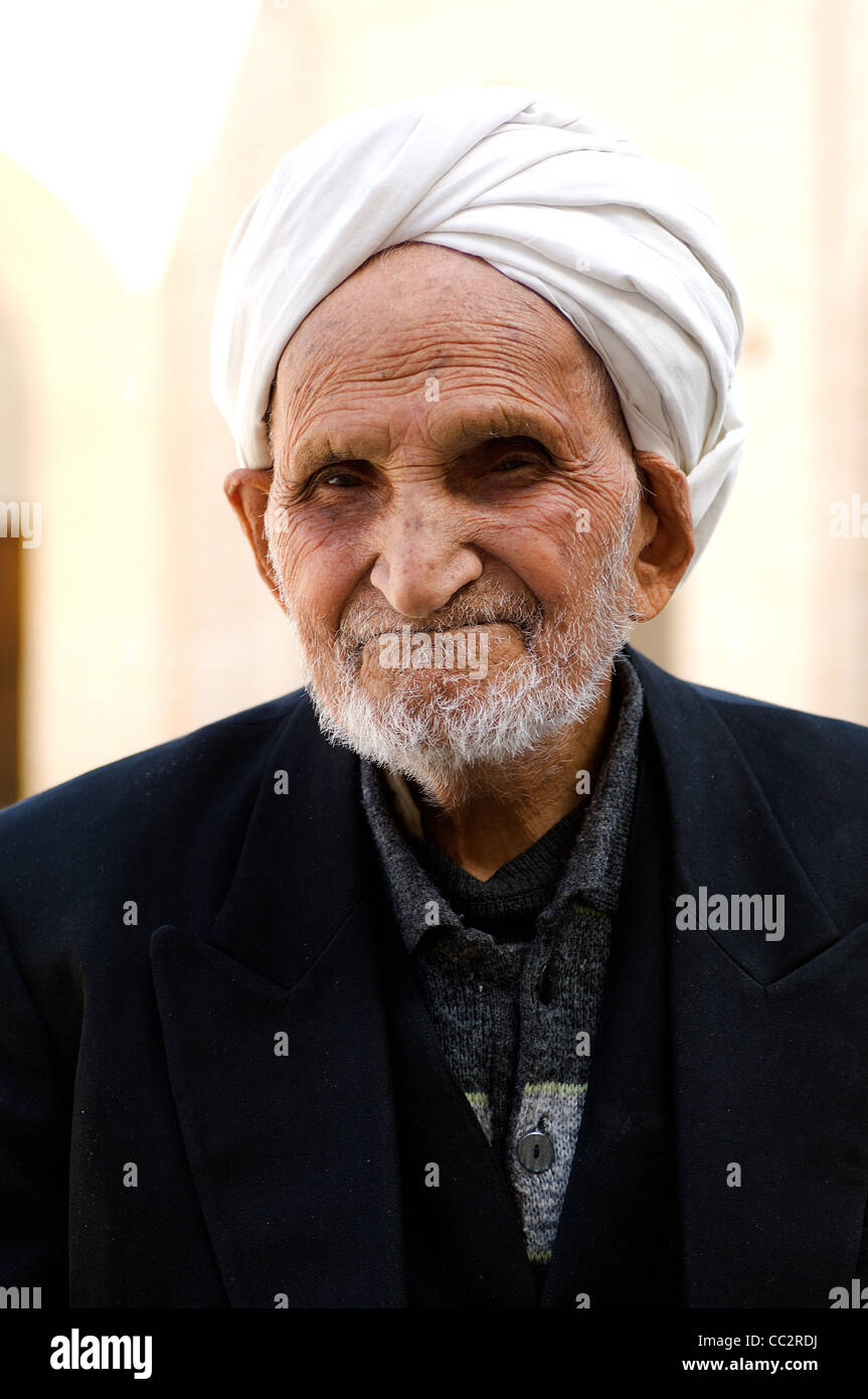A smiling old man in Yazd, Iran, with jug ears and a white turban Stock ...