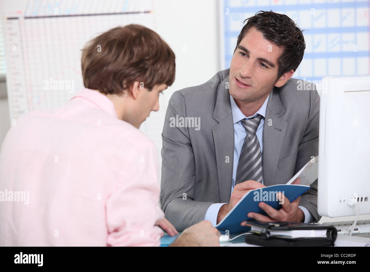 Tutor advising his student Stock Photo - Alamy