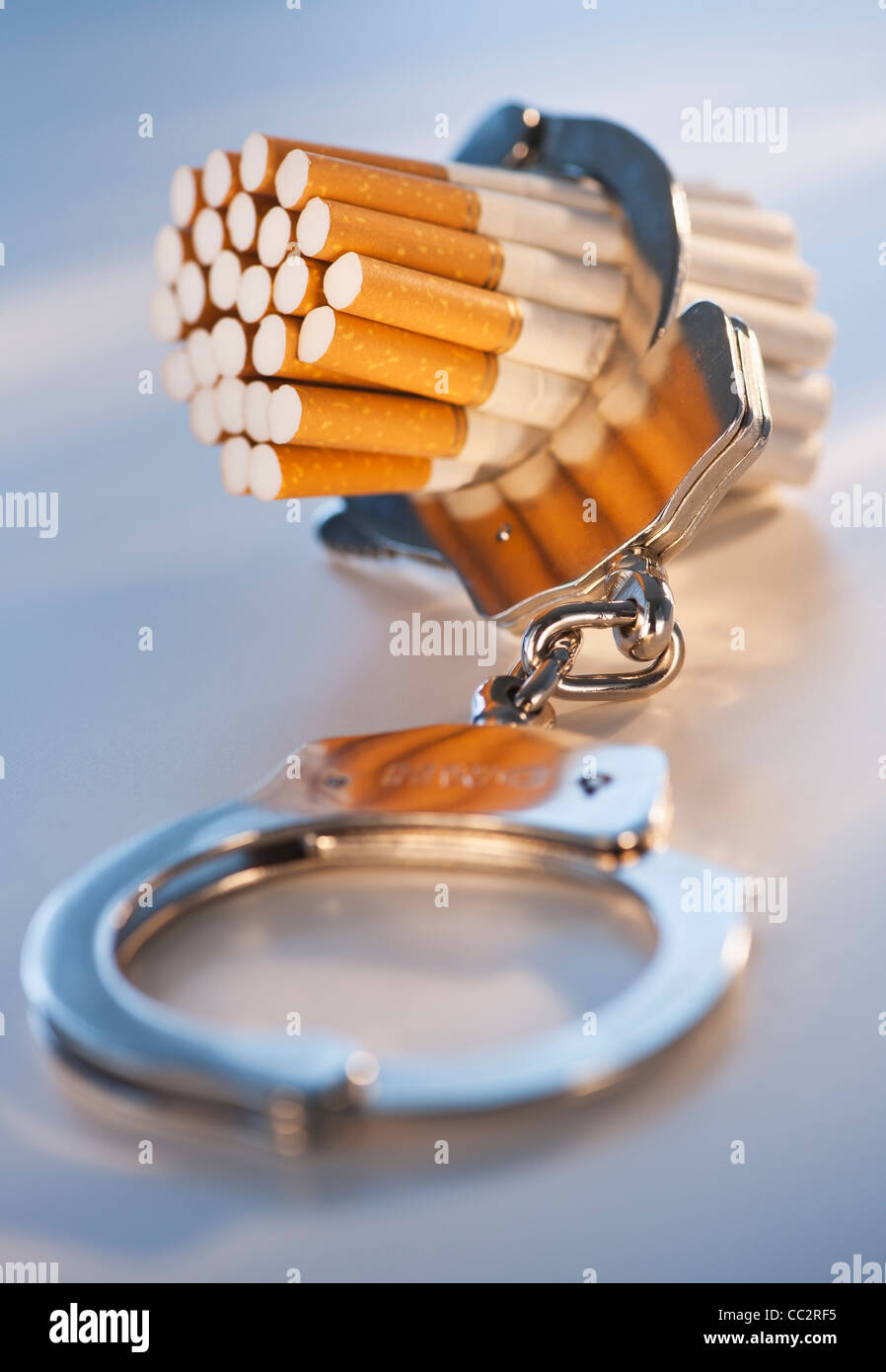 Close up of bunch of cigarettes locked in handcuffs Stock Photo - Alamy