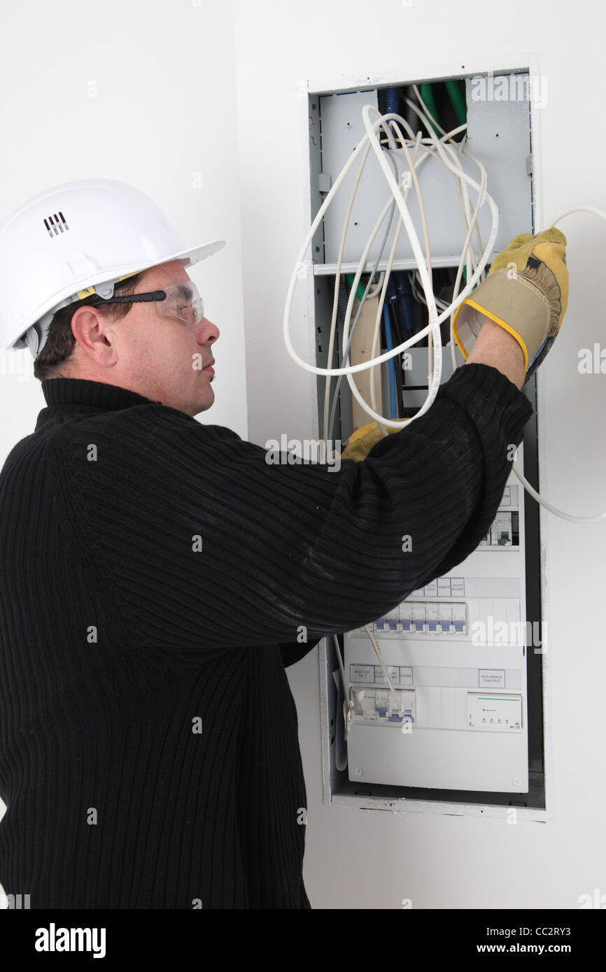 Electrician installing electric meter Stock Photo - Alamy
