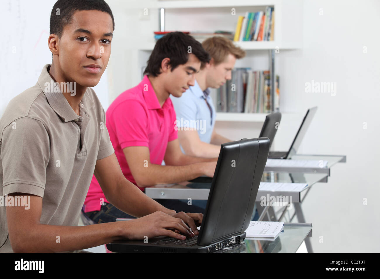 Young men working on their assignments in a computer lab Stock Photo ...
