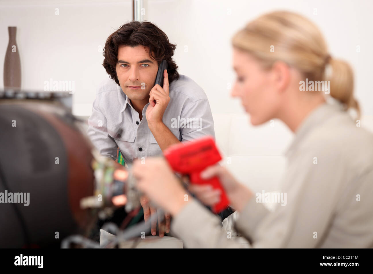 Technician fixing a television Stock Photo - Alamy