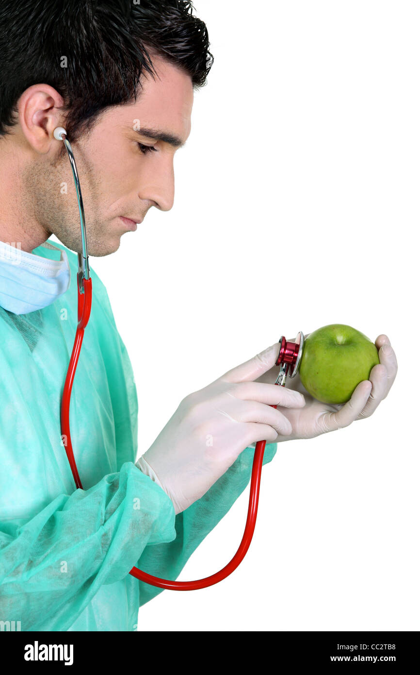 doctor examining an apple with a stethoscope Stock Photo - Alamy