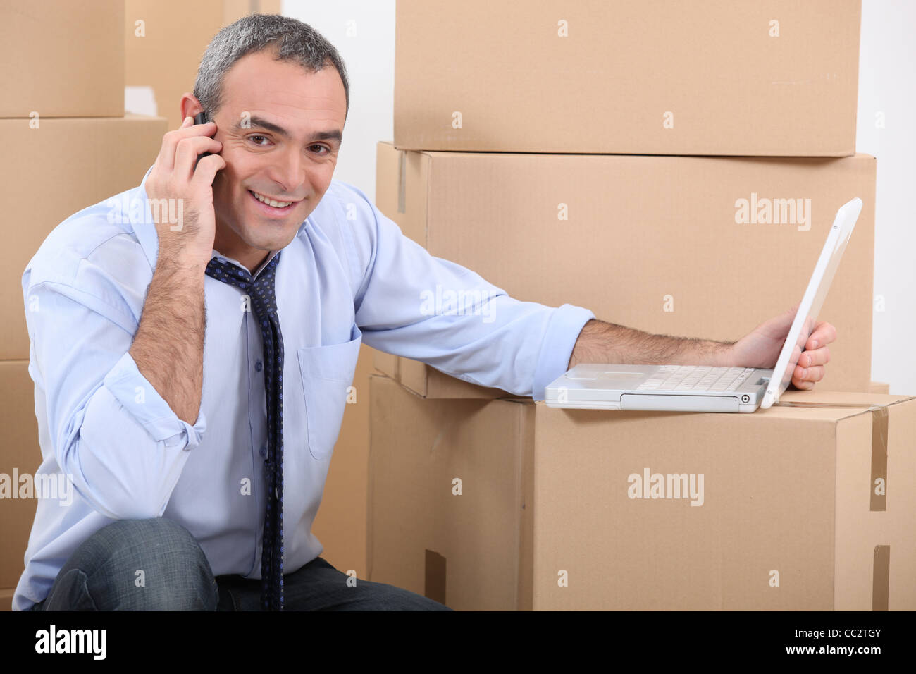 portrait of a man with moving boxes Stock Photo - Alamy