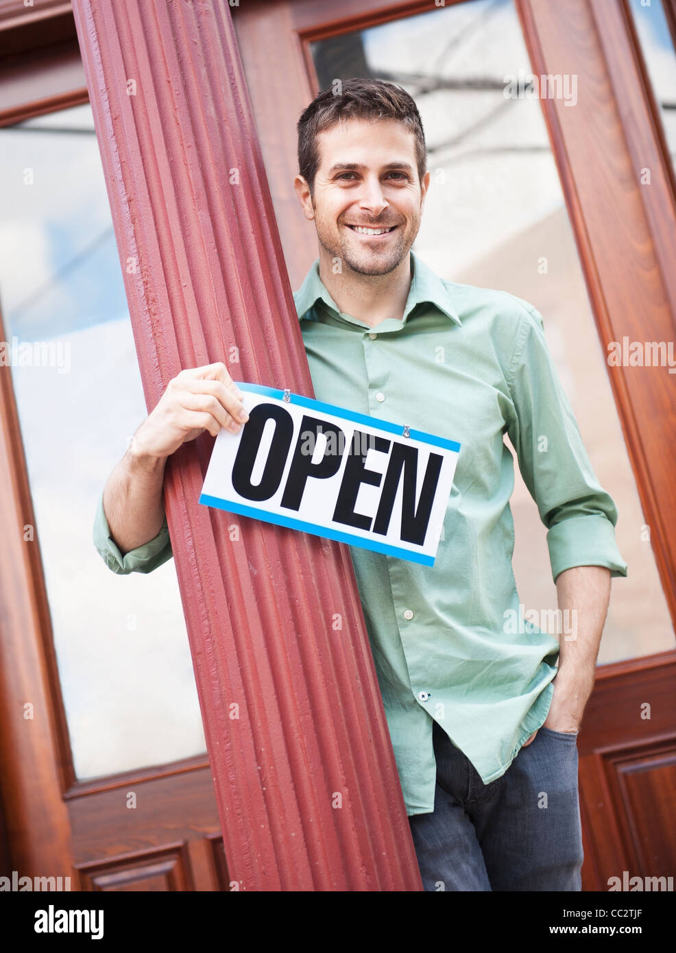 USA, New Jersey, Jersey City, Portrait of man with 'open' sign Stock ...