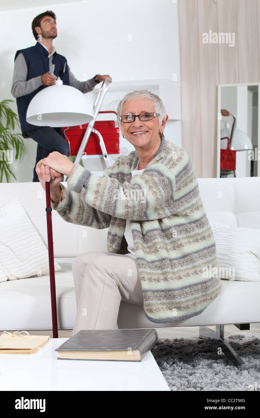 Son putting up lamp-shade Stock Photo - Alamy