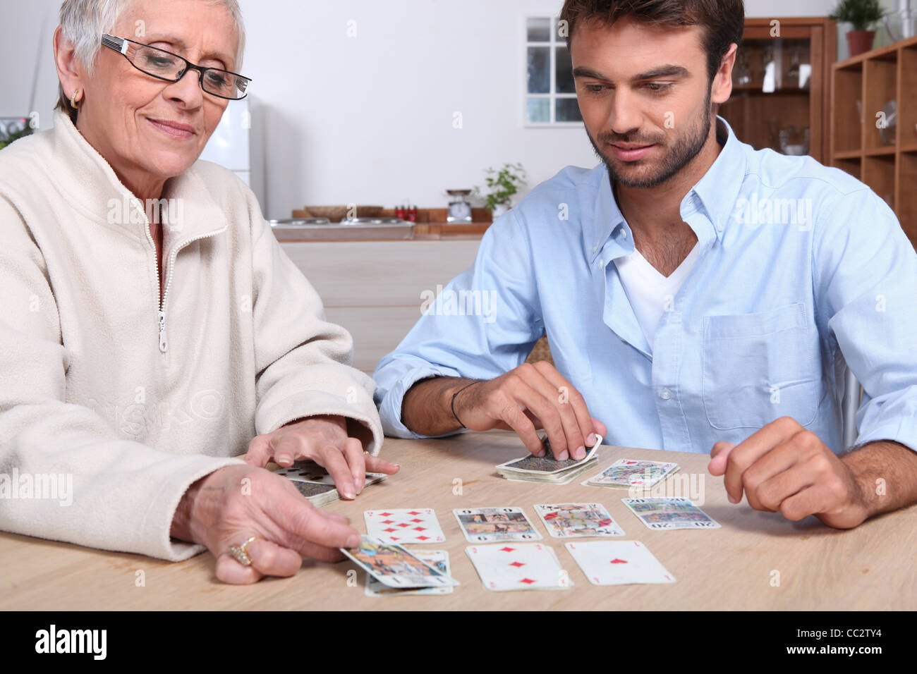 Mother and son playing cards Stock Photo - Alamy