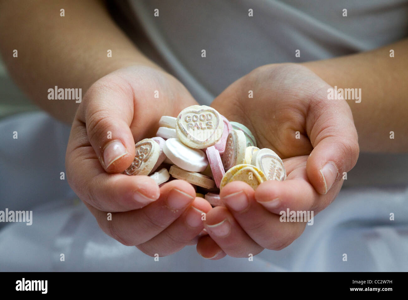 Sugar confection childs hand hi-res stock photography and images - Alamy