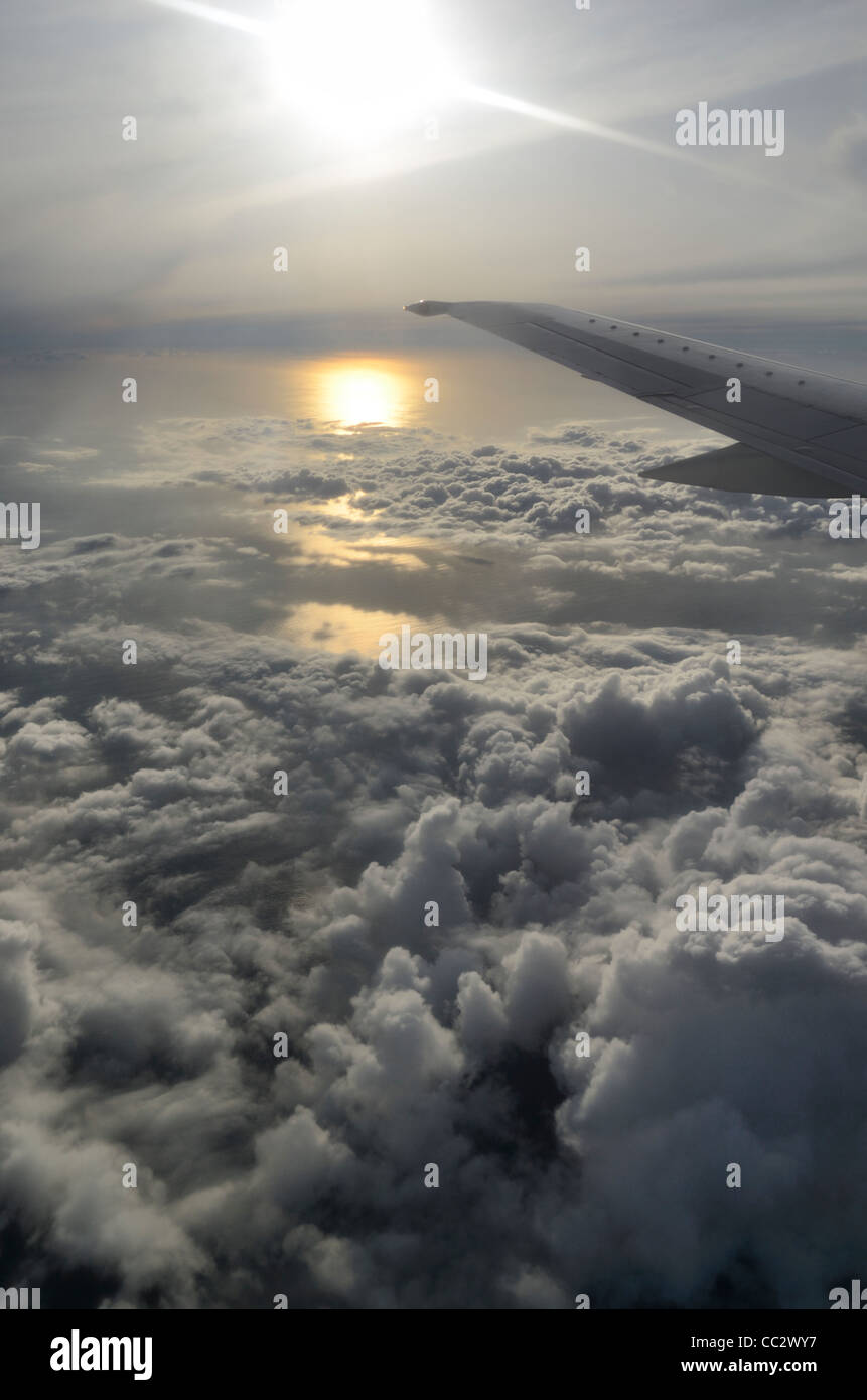 View from window of Boeing 737 flying over clouds in later afternoon in ...