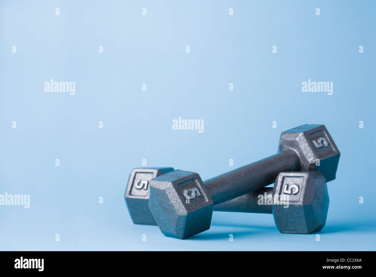 Pair of dumbbells on blue background Stock Photo - Alamy