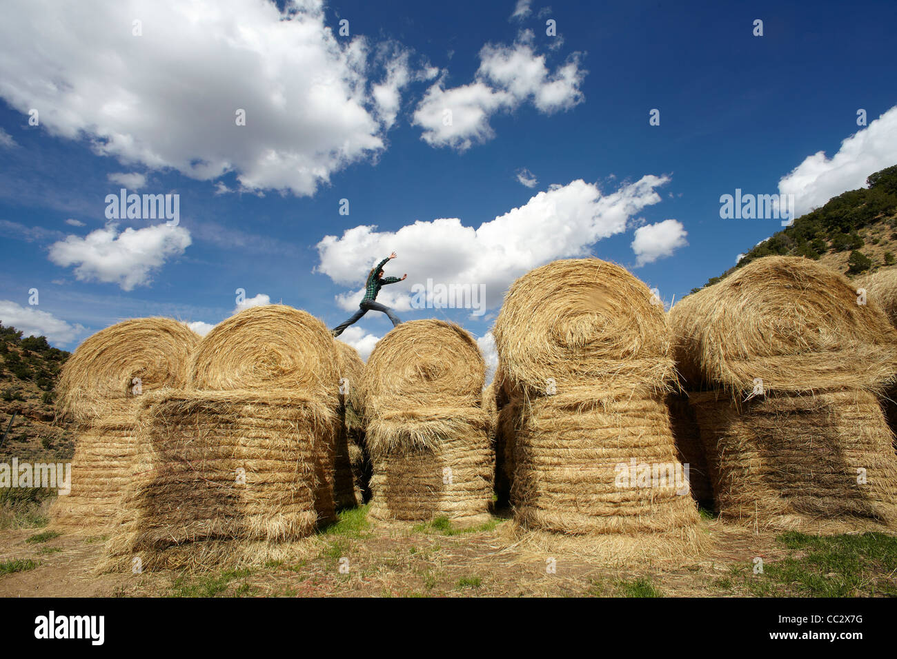 USA, Colorado, Woman jumping on haystacks Stock Photo - Alamy