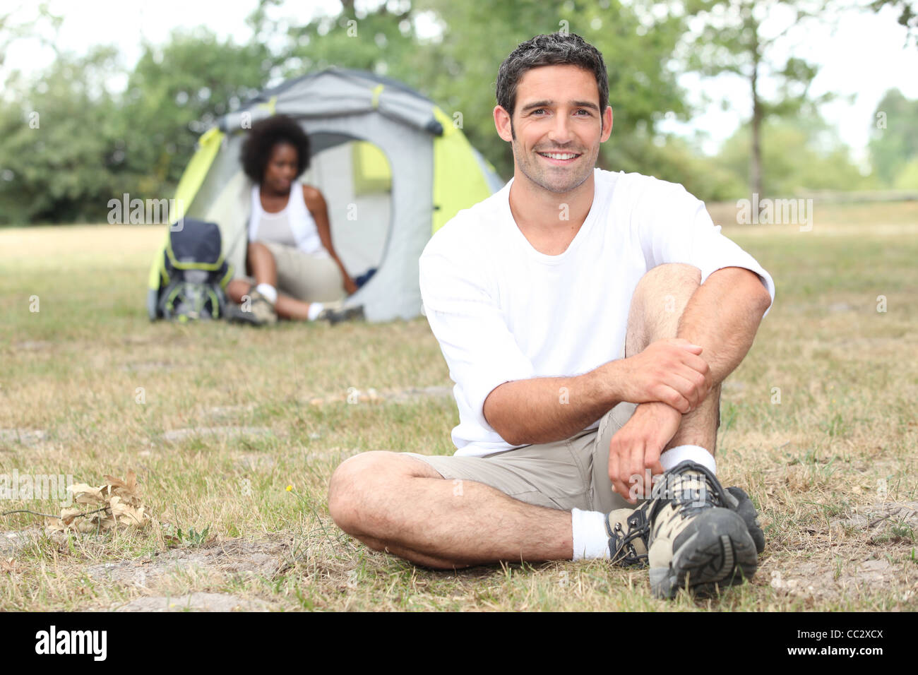 Mixed race couple camping in tent Stock Photo - Alamy