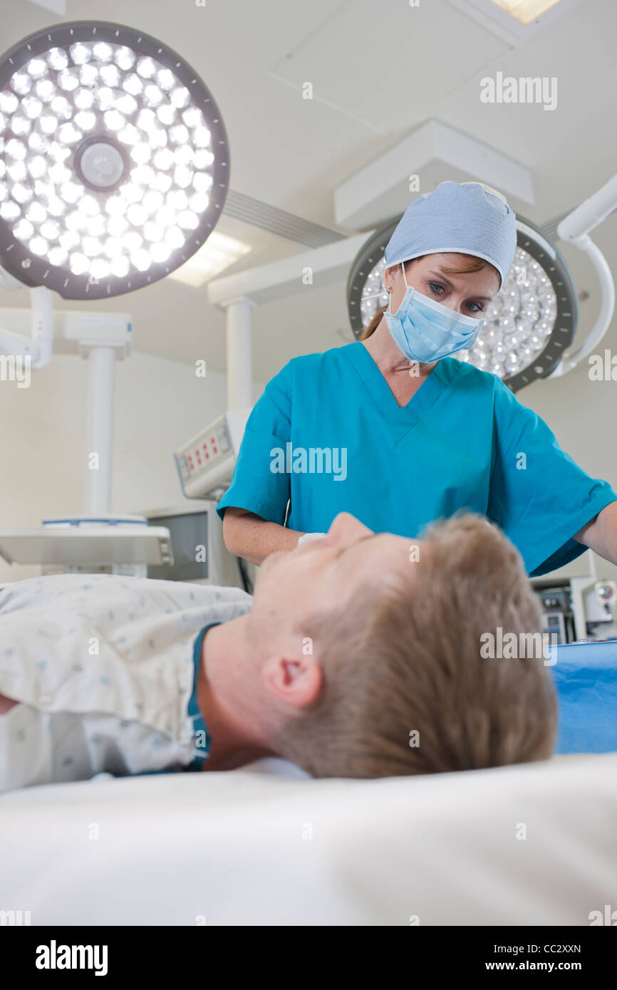 USA, Arizona, Phoenix, Surgeon preparing patient for surgery Stock ...